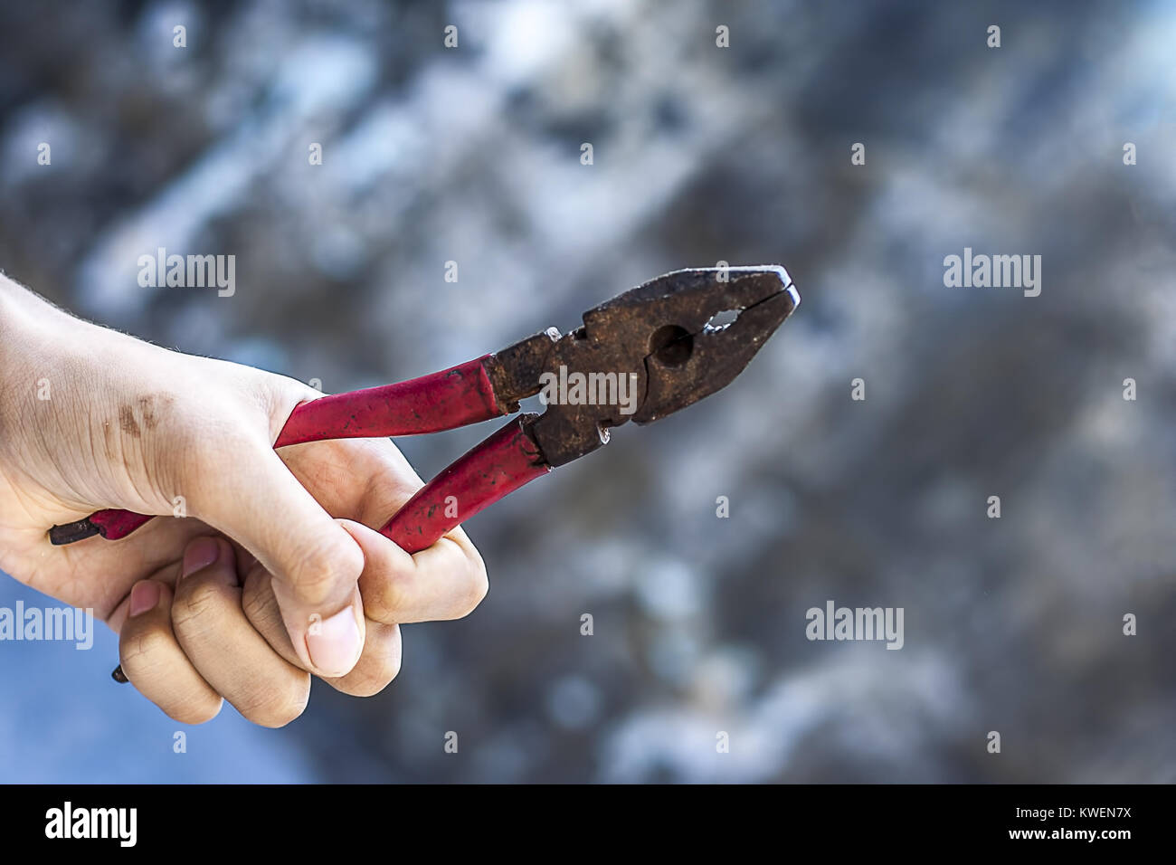 A hand holding pliers Stock Photo - Alamy