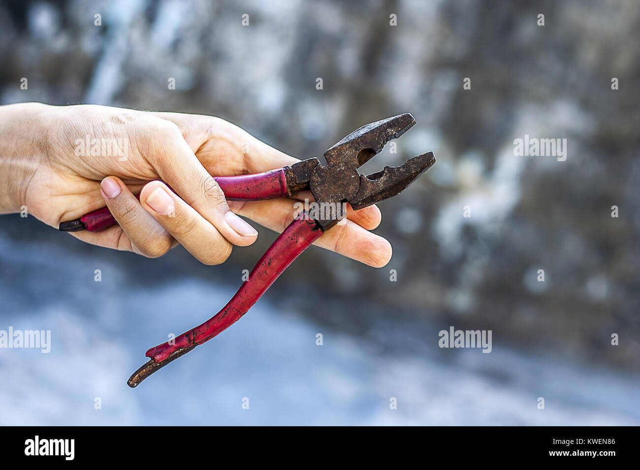 A hand holding pliers Stock Photo - Alamy