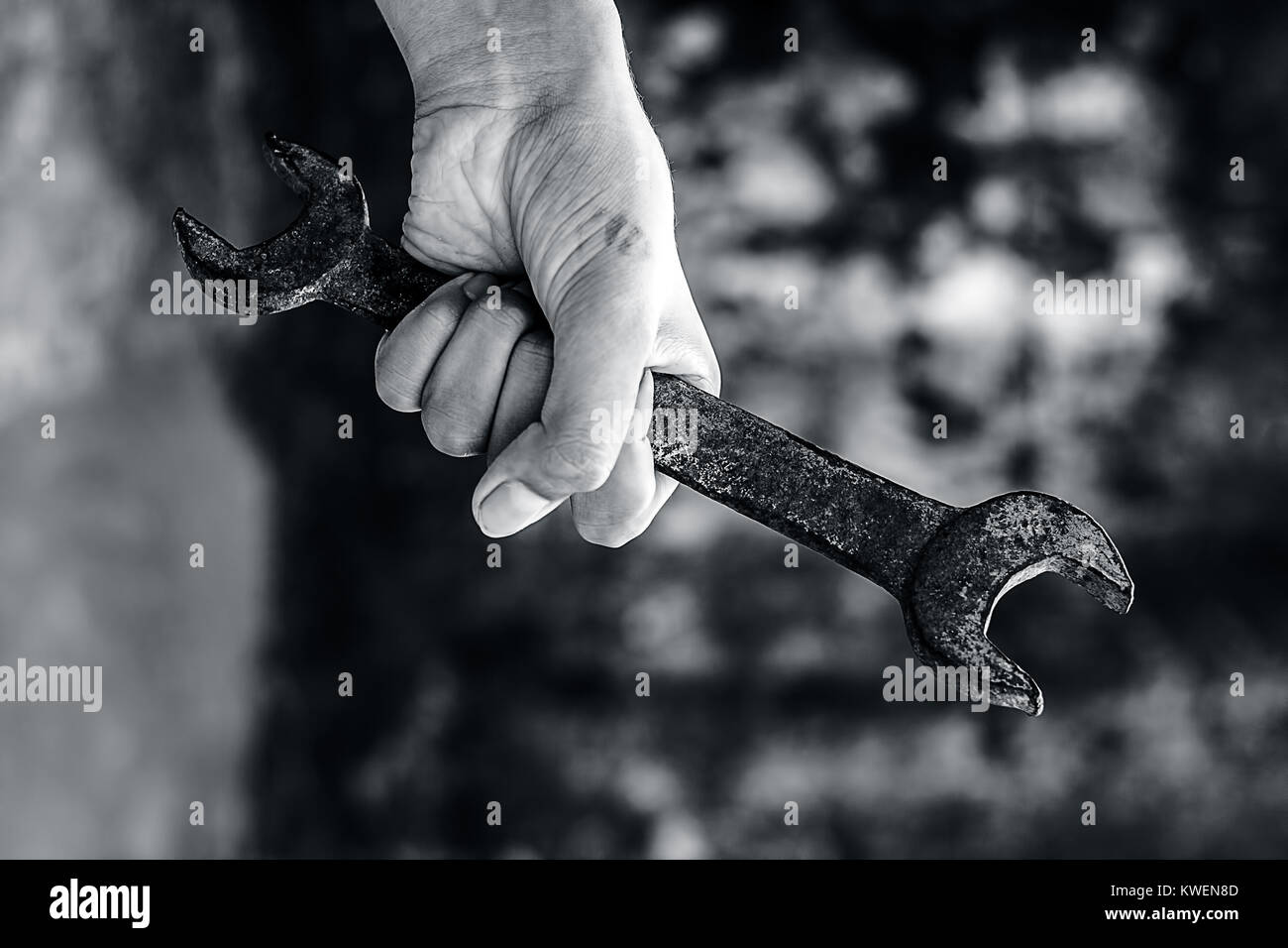 human hand holding old rusted spanner Stock Photo - Alamy