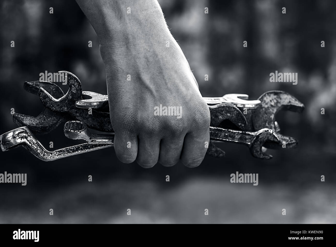 human hand holding old rusted spanner Stock Photo - Alamy