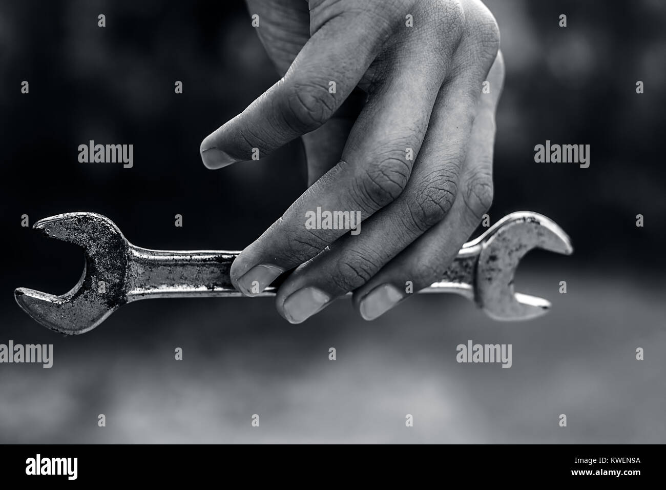 human hand holding old rusted spanner Stock Photo - Alamy