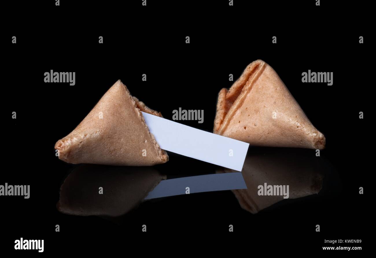 Cracked fortune cookie isolated on black background Stock Photo - Alamy