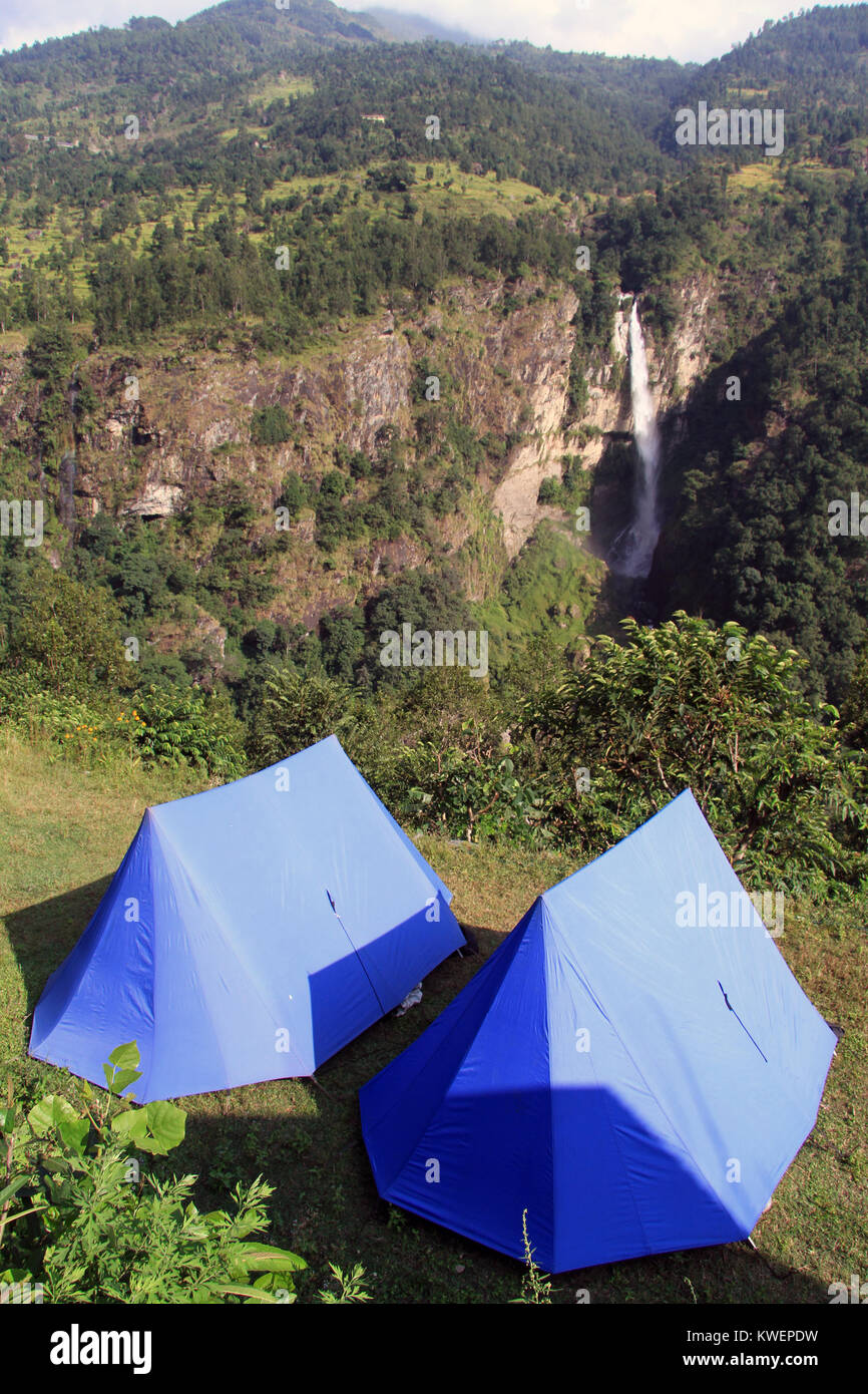 Blue tourist tents and waterfall near Manaslu, Nepal Stock Photo - Alamy