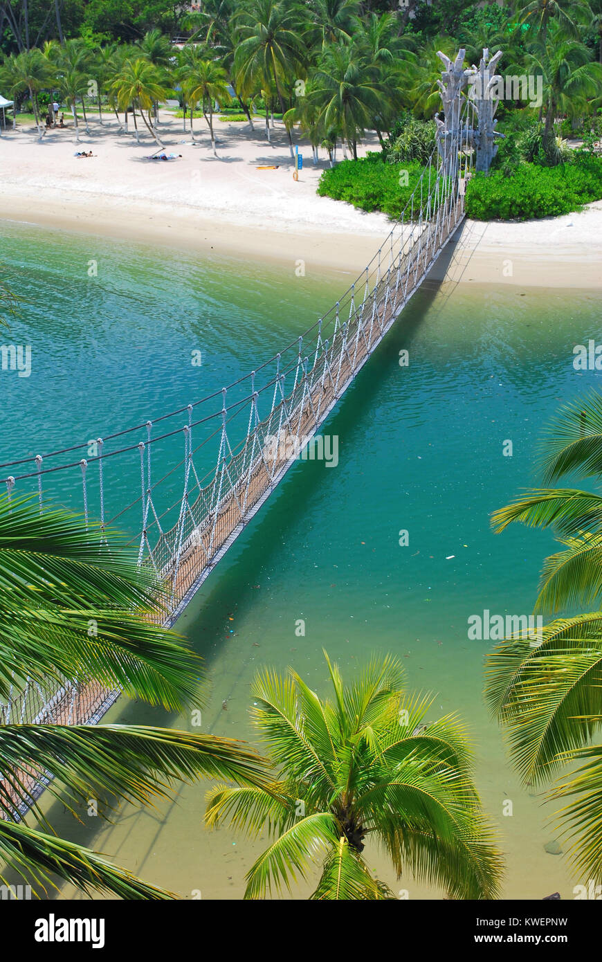 Wooden suspension bridge leading to paradise island surrounded by ...