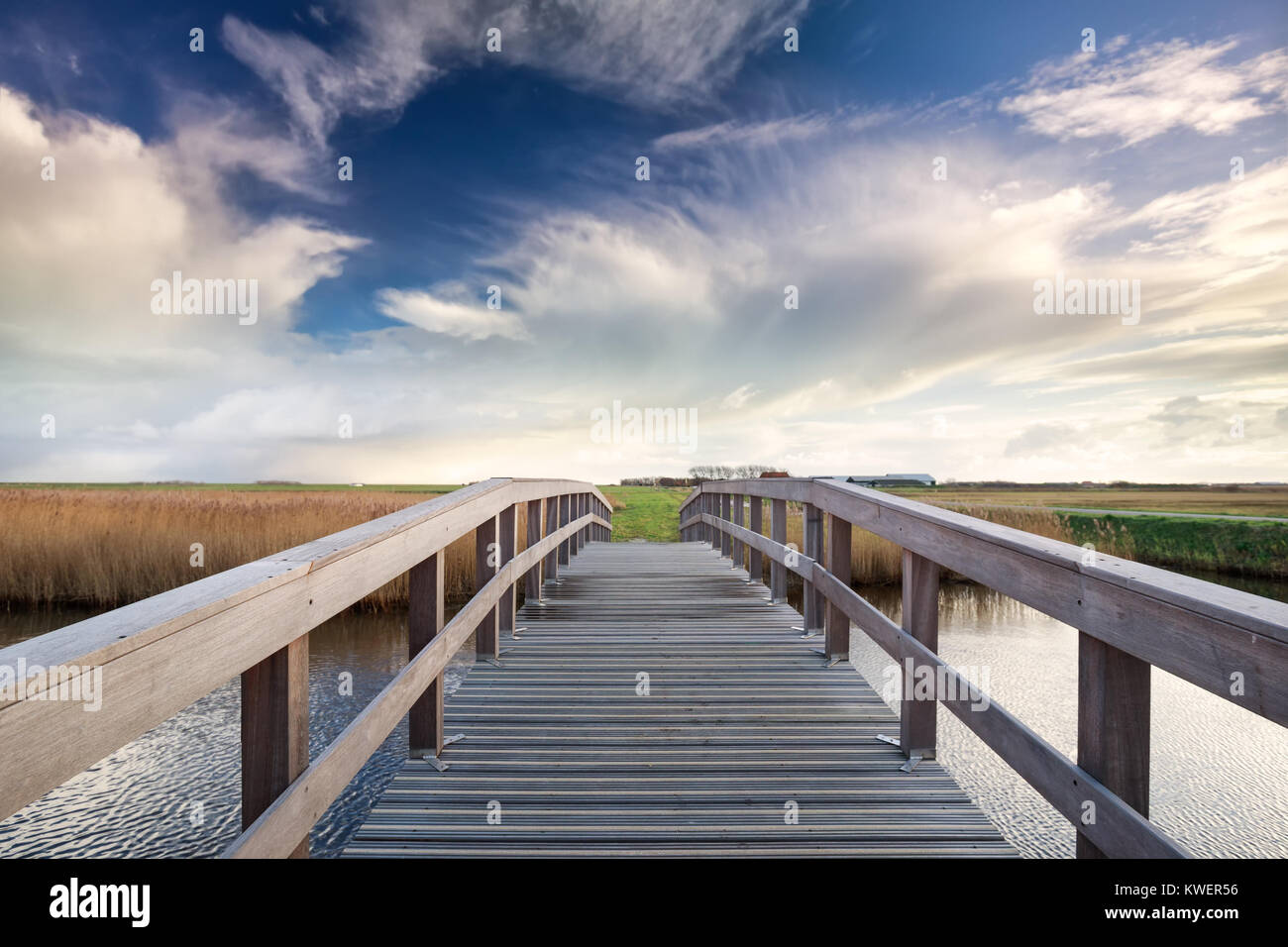 wooden bridge via river and blue sky Stock Photo - Alamy