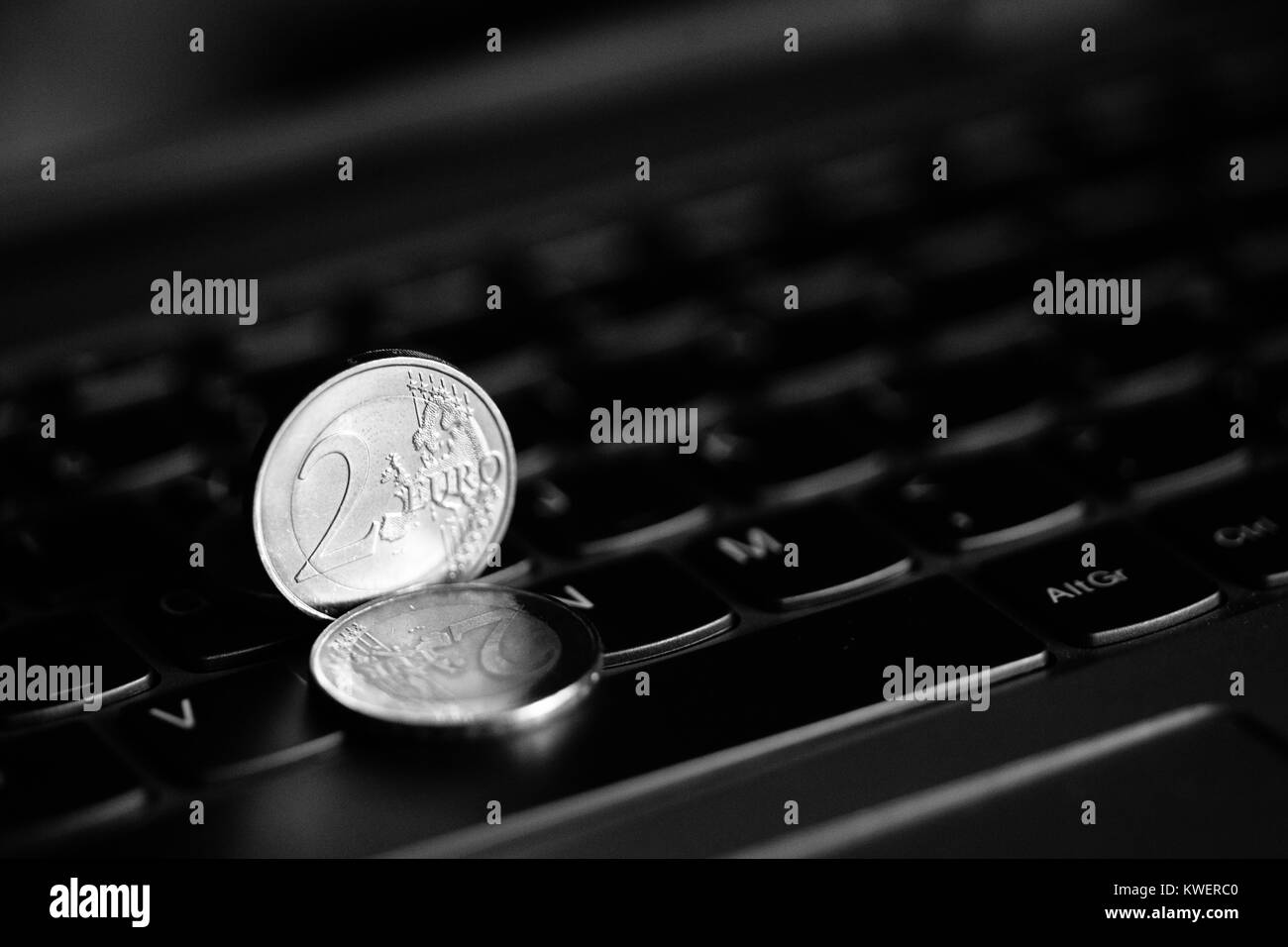 Euro coins on laptop's keyboard - make money online Stock Photo - Alamy