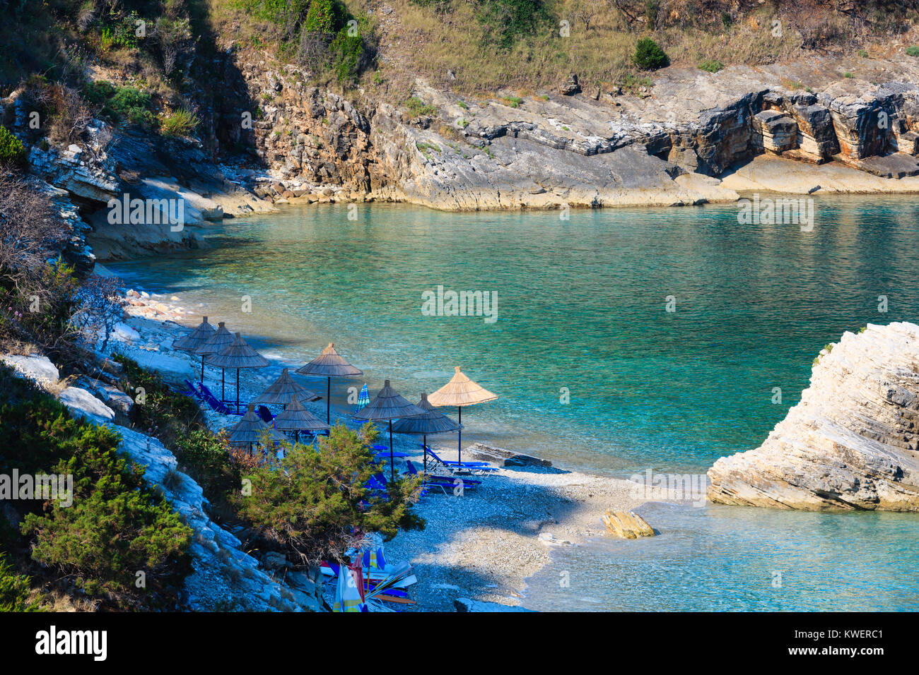Summer morning Pulebardha beach with sunbeds and sunshades (Saranda ...