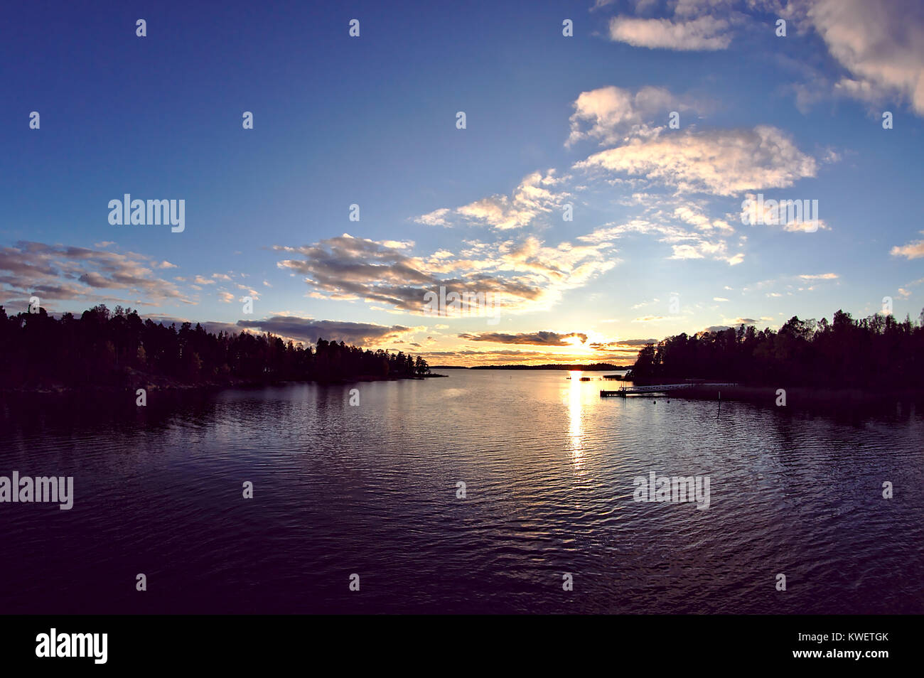 Beautiful colorful sunset reflecting from water surface Stock Photo - Alamy