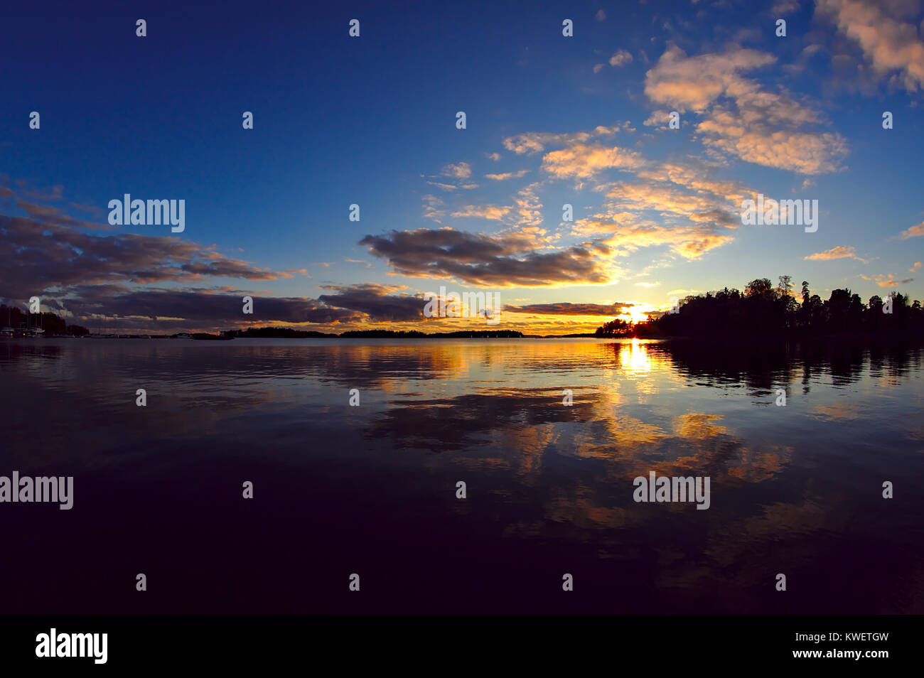 Beautiful colorful sunset reflecting from water surface Stock Photo - Alamy