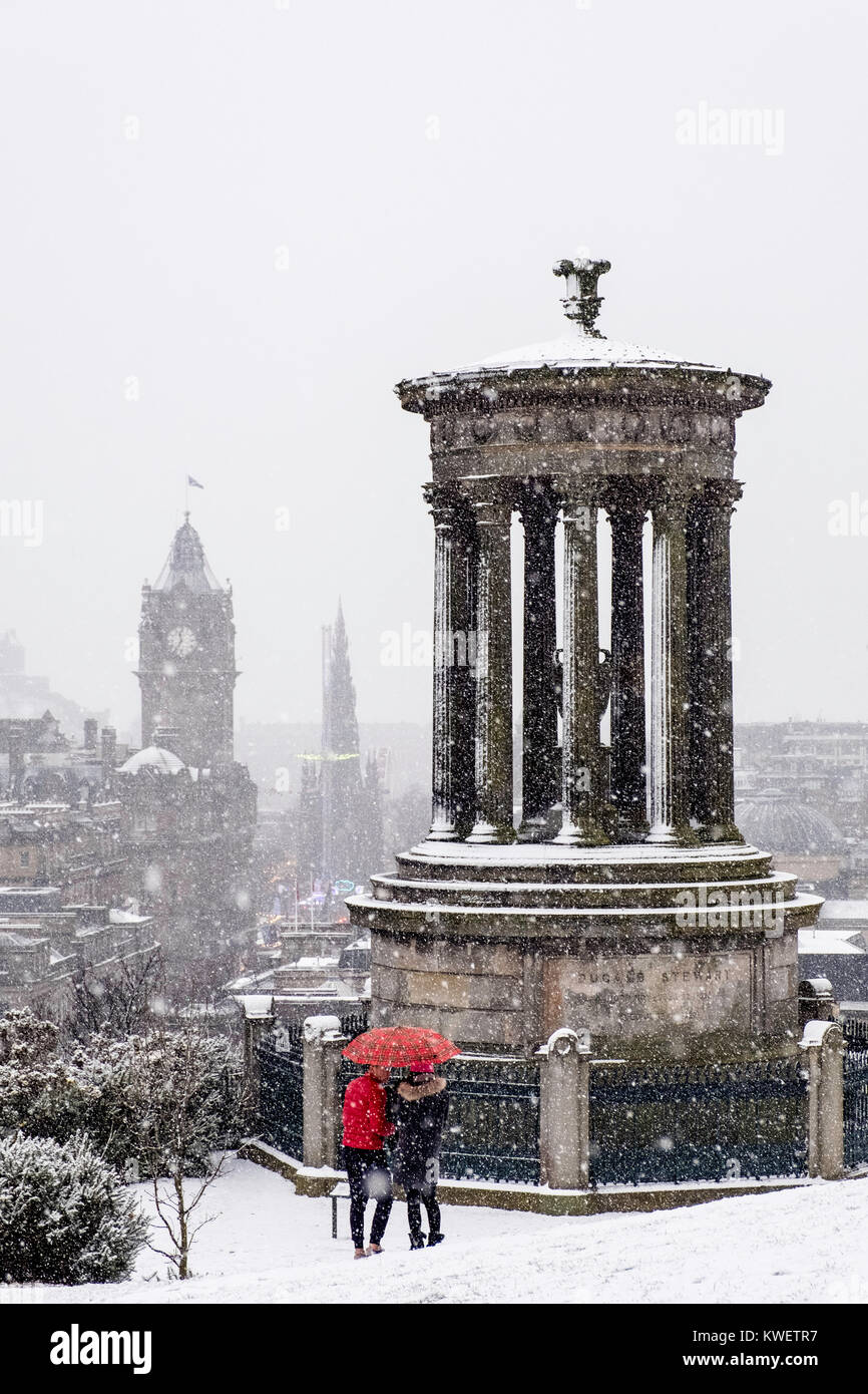 Snow falls on city of Edinburgh in December. Skyline view of city from ...