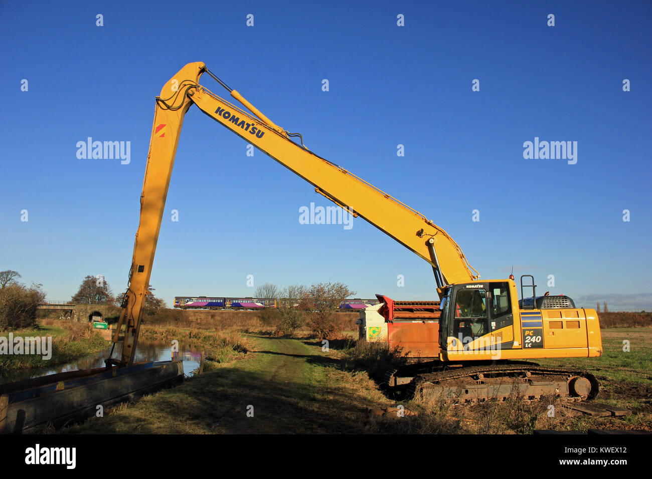 A Northern Railway train passes behind a digger that will be used in ...