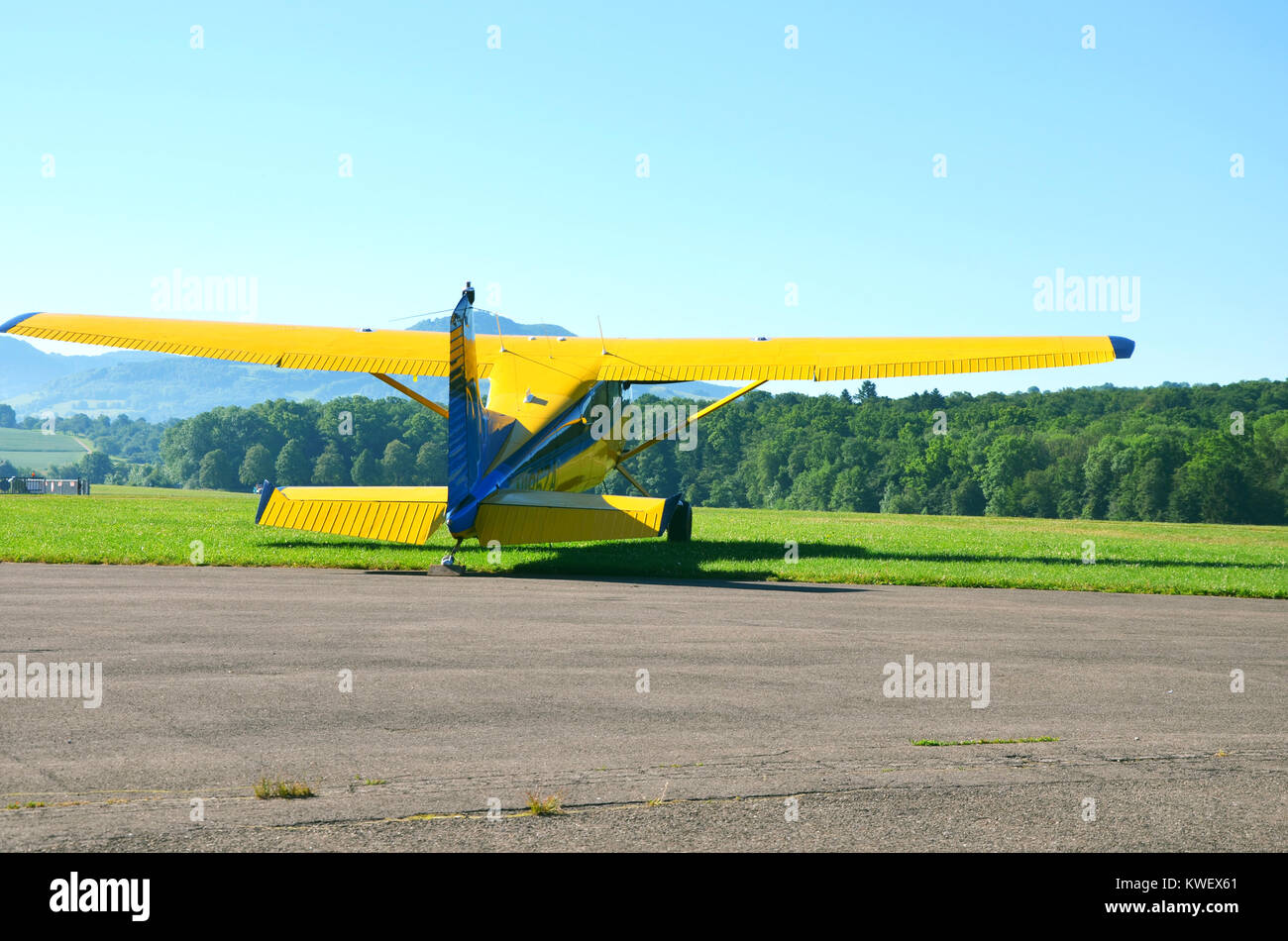 A small yellow plane ready for takeoff, seen at Hahnweide, Stuttgart ...