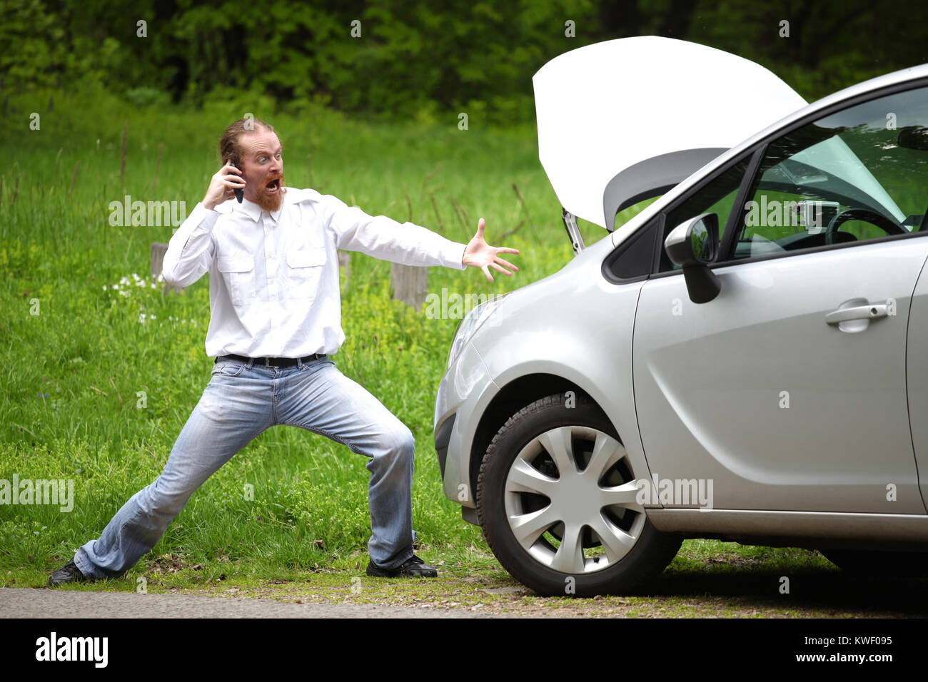 Driver furious with mobile phone a broken car by the road Stock Photo ...