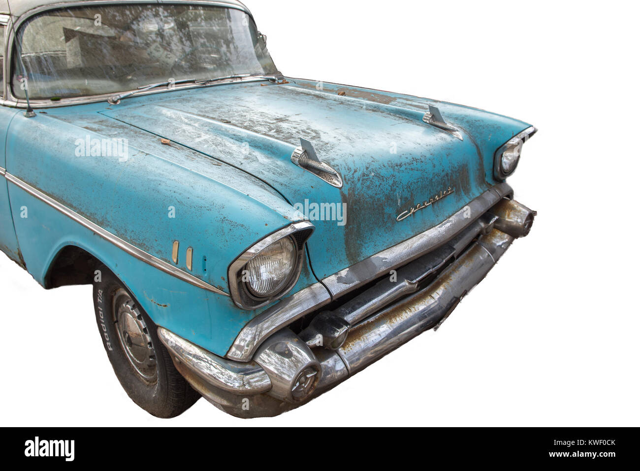 Old, abandoned Chevrolet rusts on the street, isolated against white ...