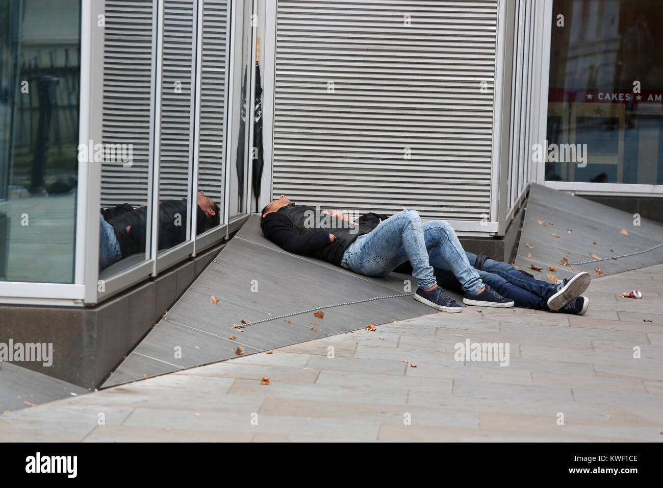 Two homeless men pictured sleeping outside a Pret Cafe in London, UK ...