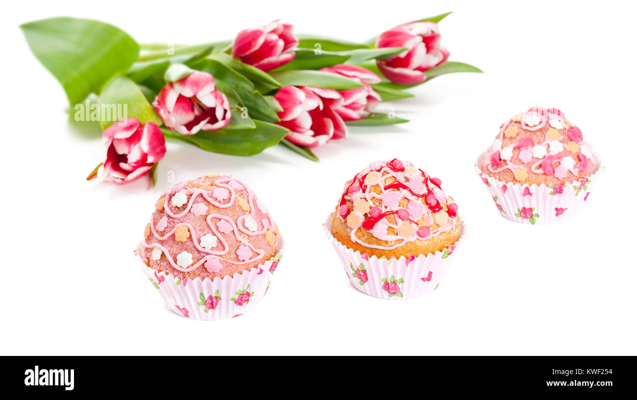 Decorated cupcakes and bunch of tulips on white background Stock Photo ...