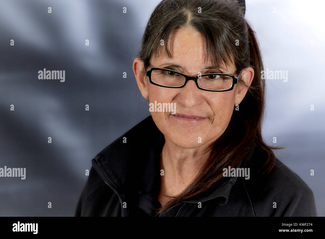 Attractive Middle aged woman with brown hair wearing black reading ...