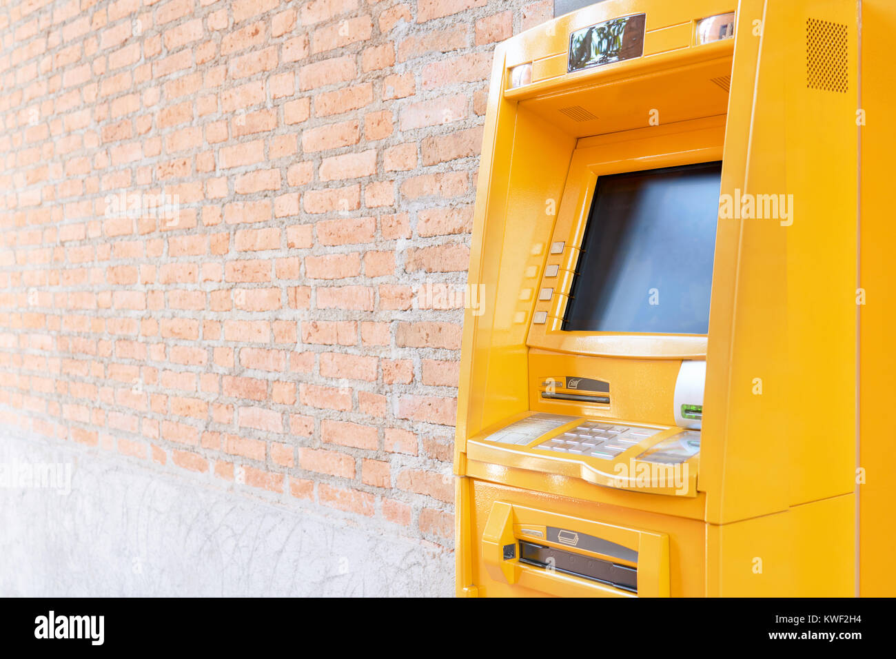 Automatic Teller Machine (ATM). Yellow cash box is located next to the brick wall. To use all ...