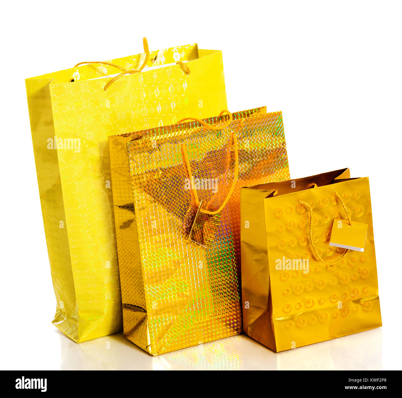 Three yellow paper bags for gifts isolated on white Stock Photo - Alamy