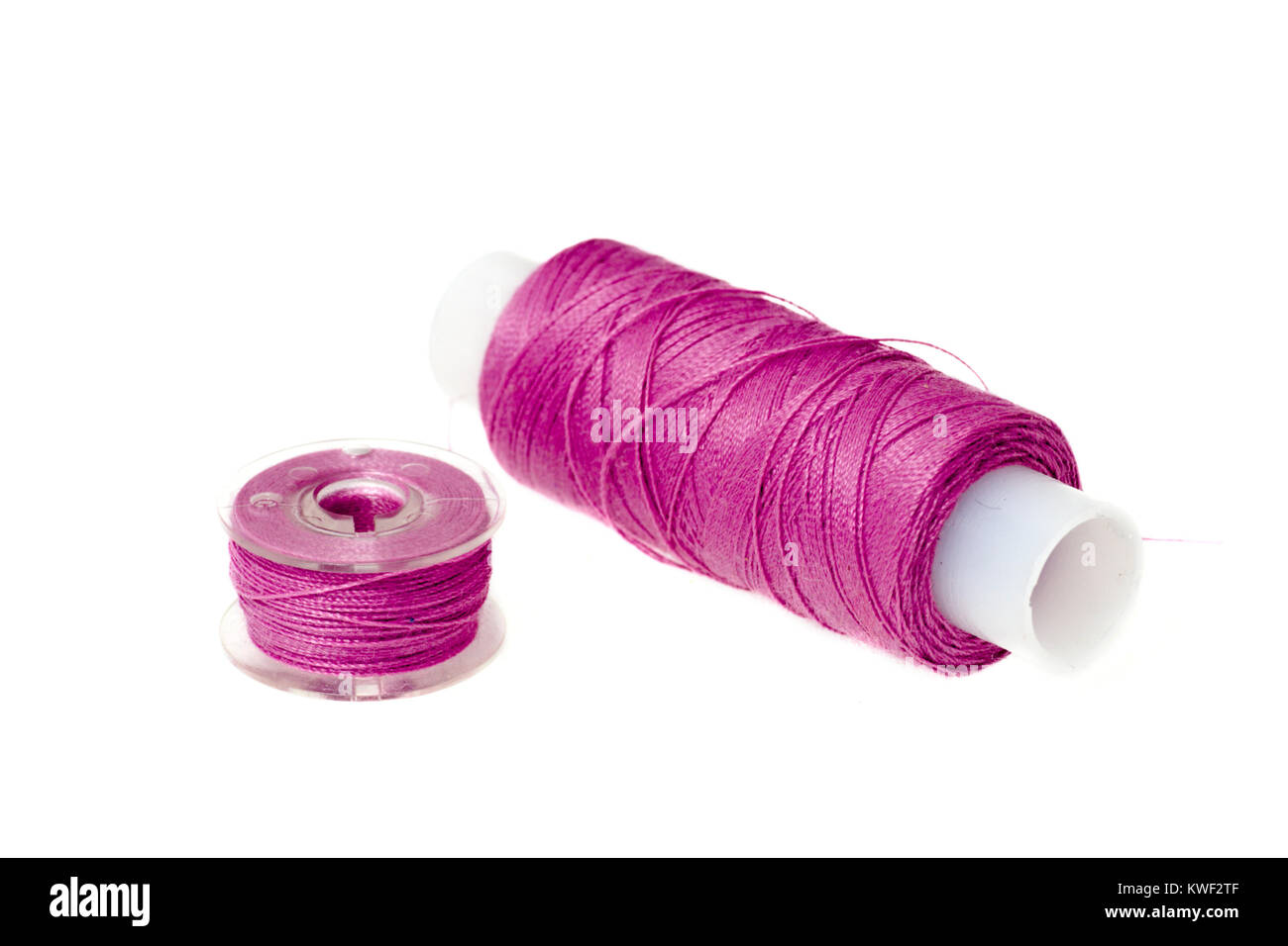 spool of pink thread isolated on white Stock Photo - Alamy