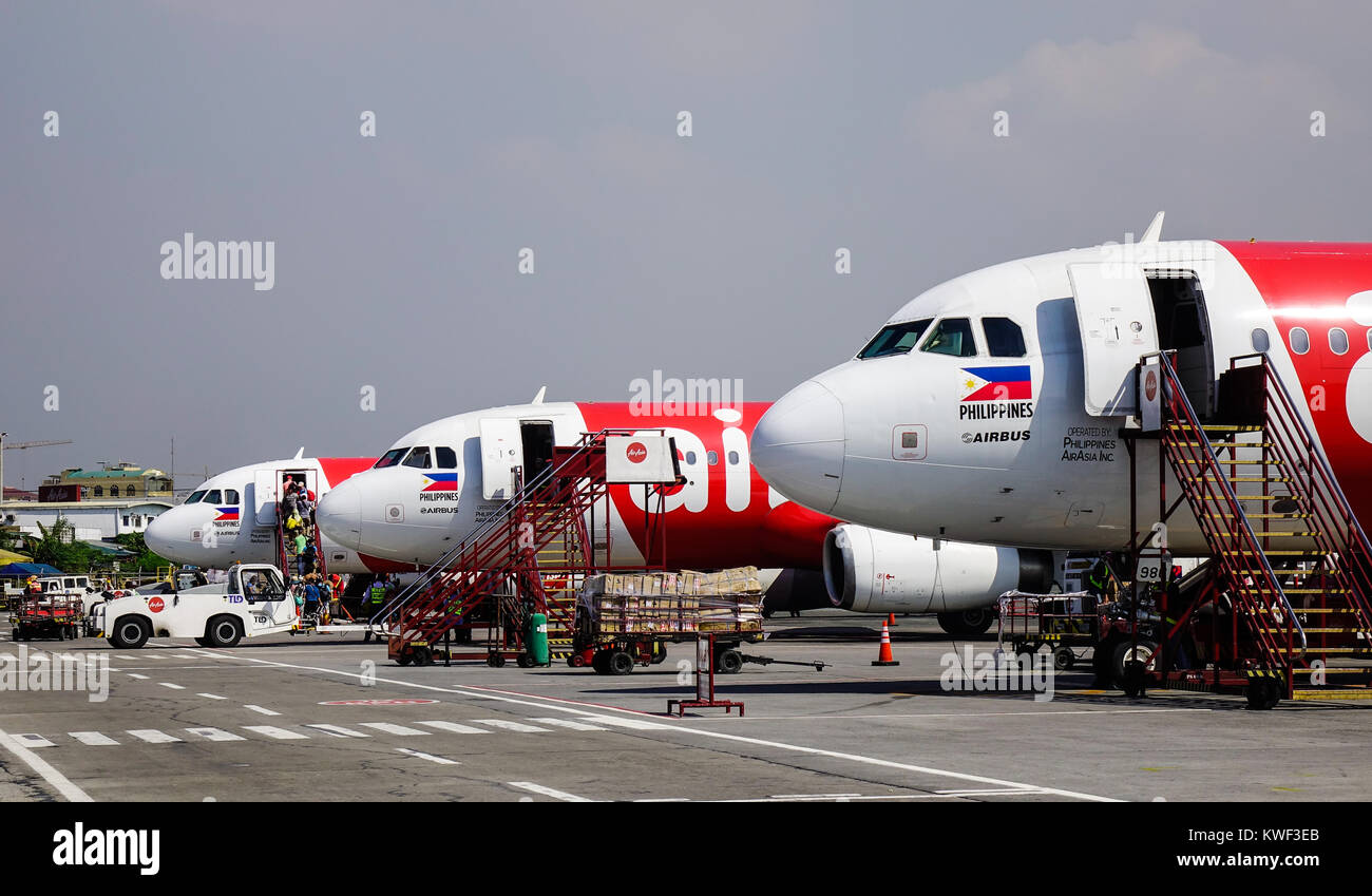 Manila, Philippines - Apr 12, 2017. AirAsia aircrafts dock at Ninoy ...