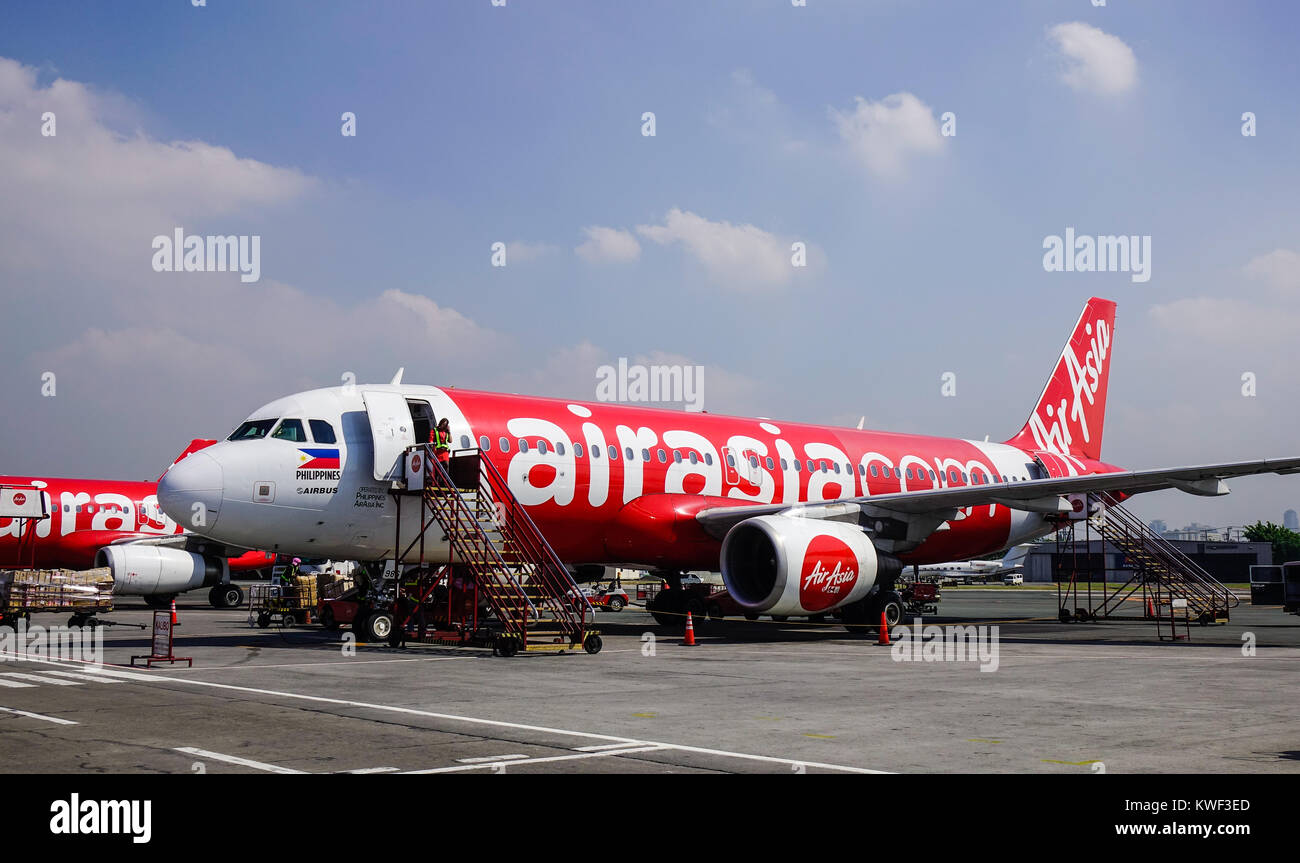 Manila, Philippines - Apr 12, 2017. AirAsia airplanes dock at Ninoy ...