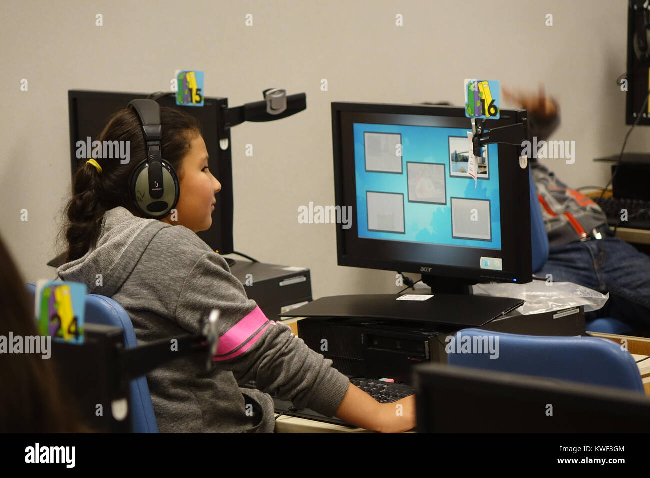 A young student learning on a school computer Stock Photo - Alamy