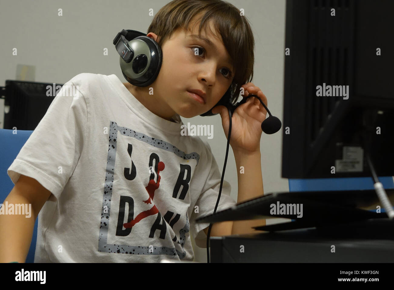 An elementary student concentrates on his computer Stock Photo - Alamy