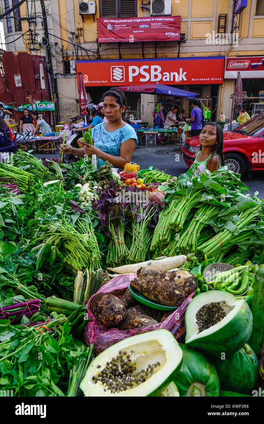 Manila, Philippines - Apr 12, 2017. A woman selling vegetable at market ...