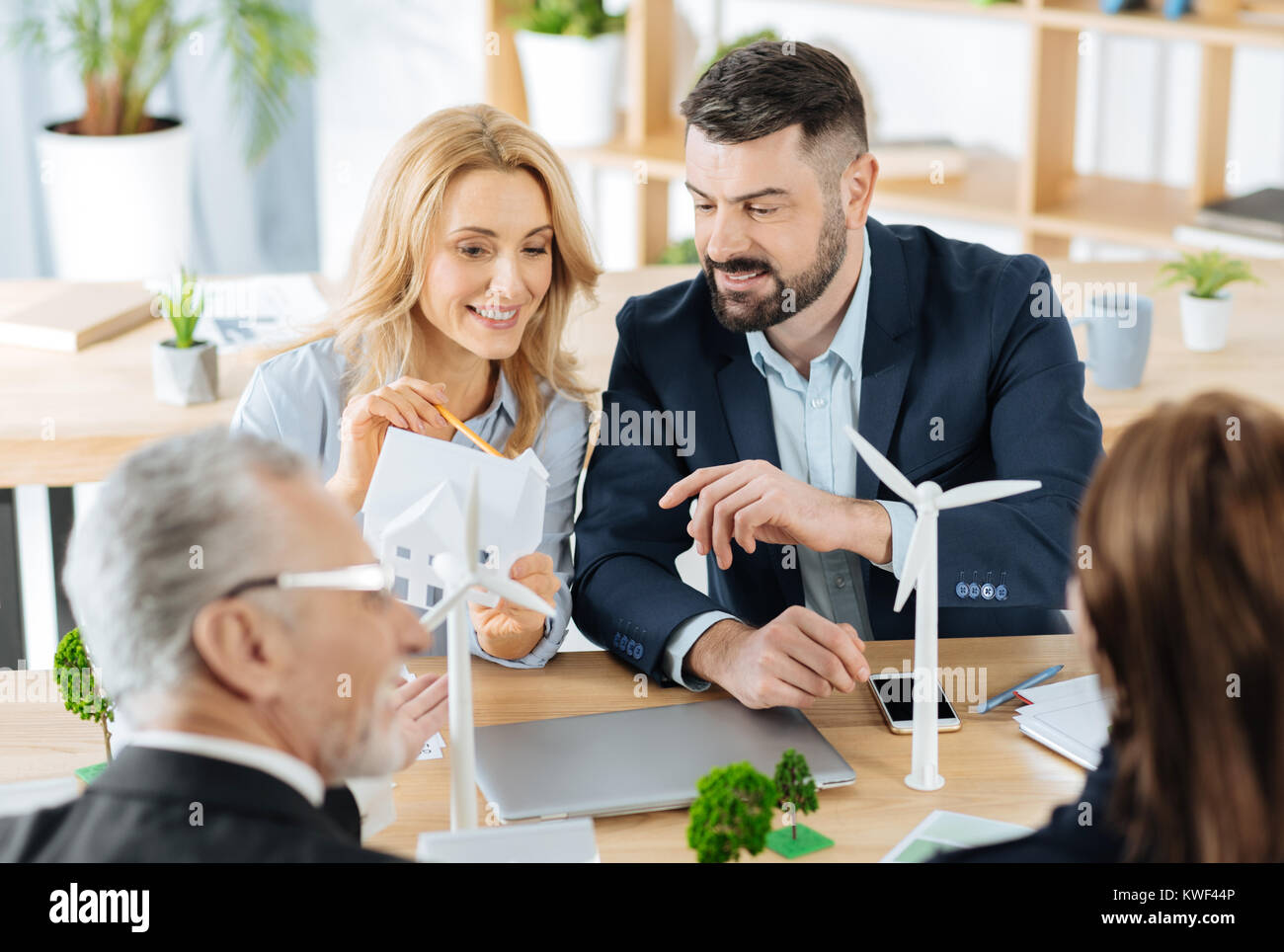 Windmill turbines. Clever progressive young engineers holding a nice ...