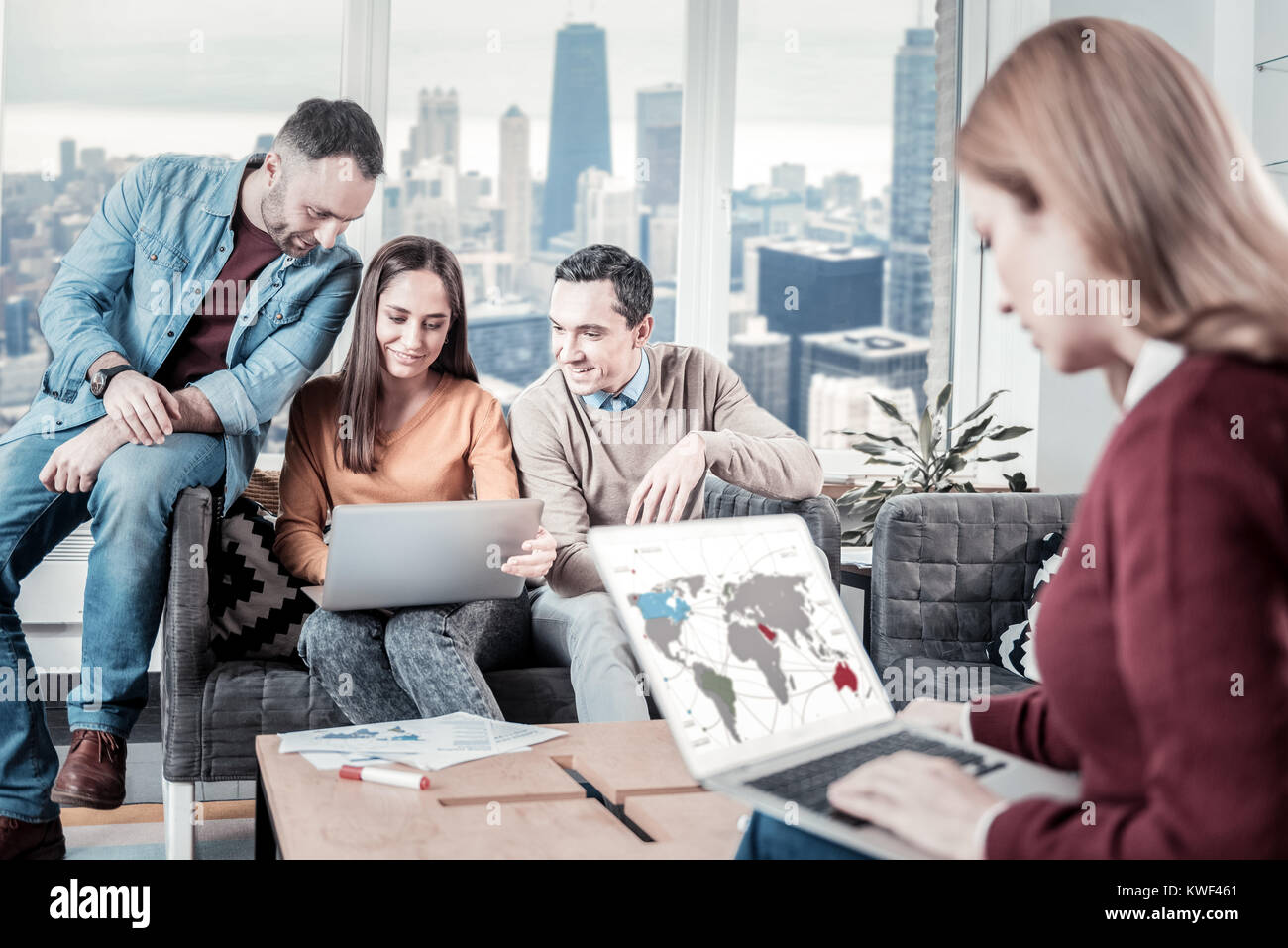 Friendly workers. Young perspective stylish employees sitting in the ...