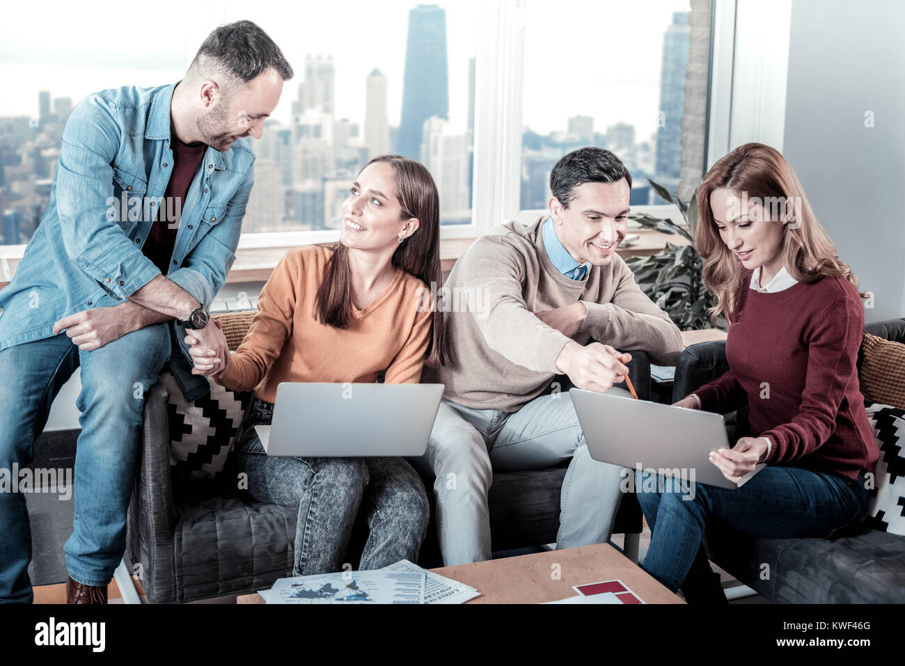 Reliable colleagues. Two nice-looking satisfied clever workers sitting ...