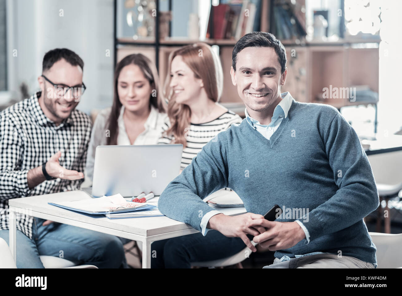 Work with best company. Handsome satisfied pleasant man sitting in the ...