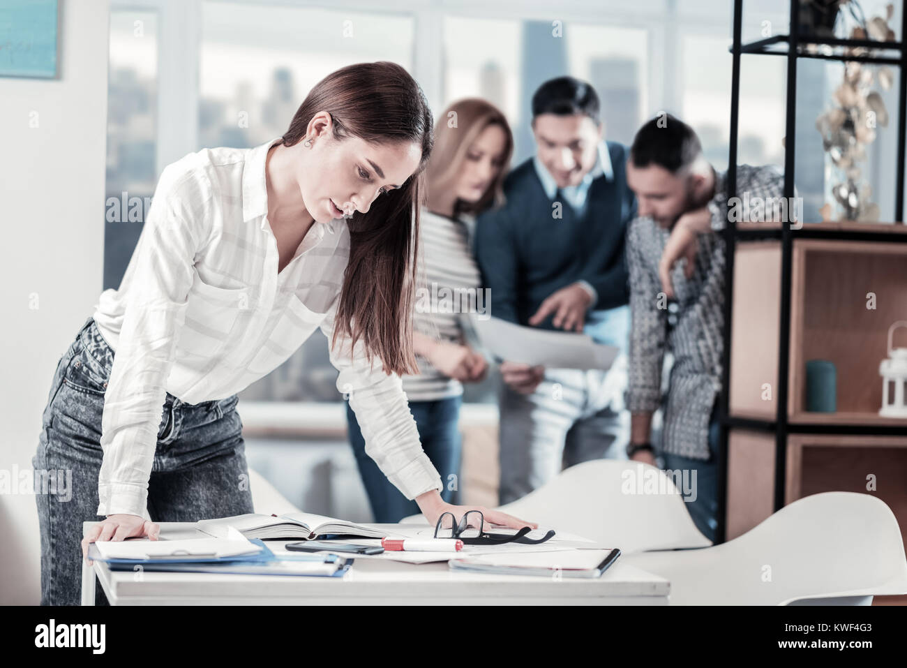 Lets check it. Pretty concentrated serious employee standing in the ...