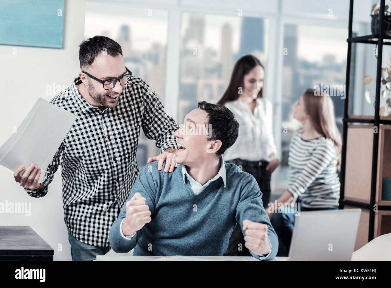 Incredibly situation. Friendly amazed nice-looking colleagues rejoicing ...