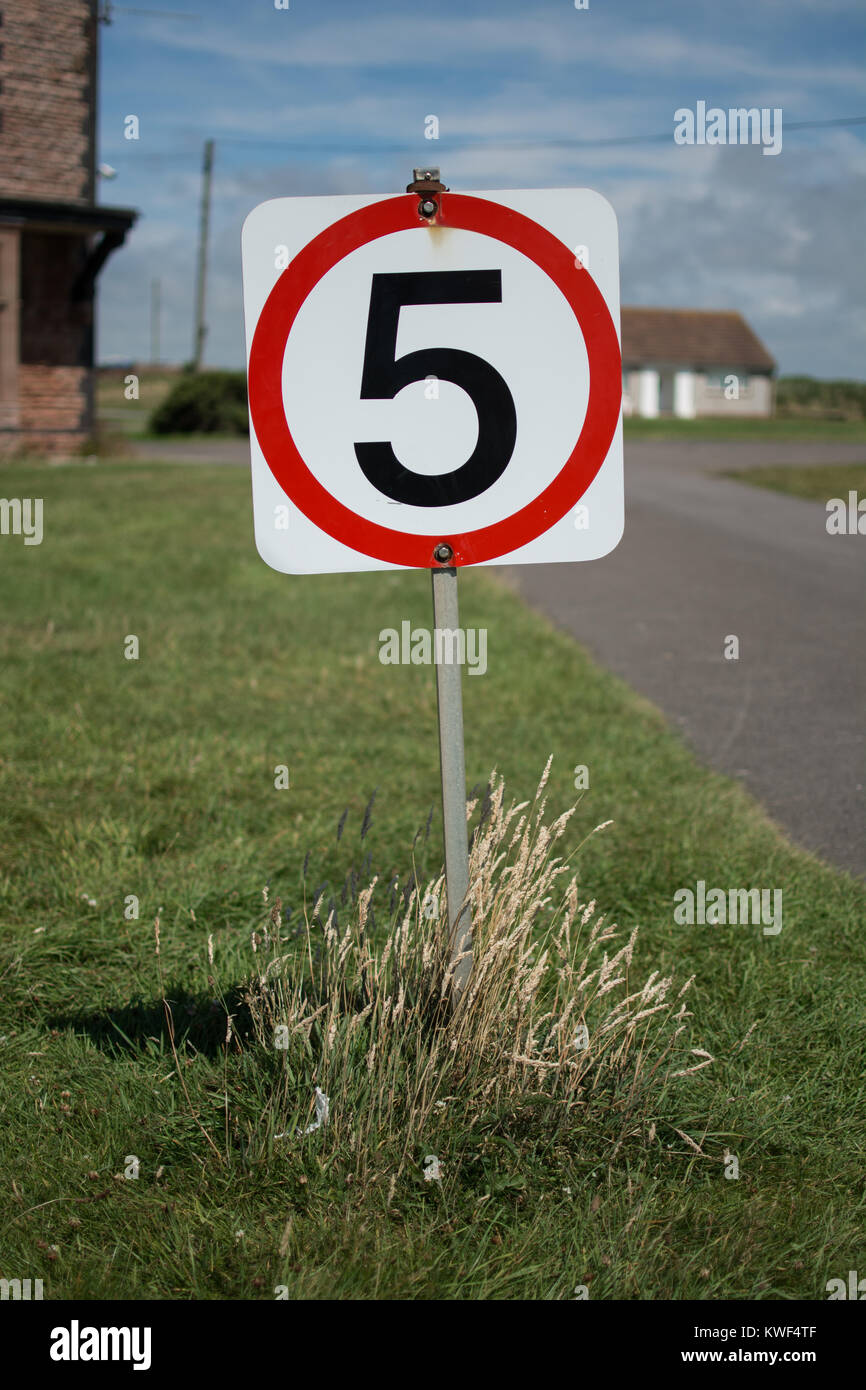 A five miles per hour sign on a grass verge Stock Photo - Alamy