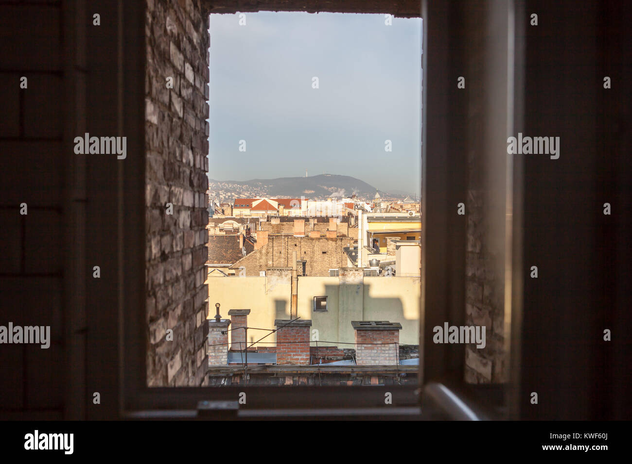 View of Budapest rooftops from a brick window in the centre of the city ...