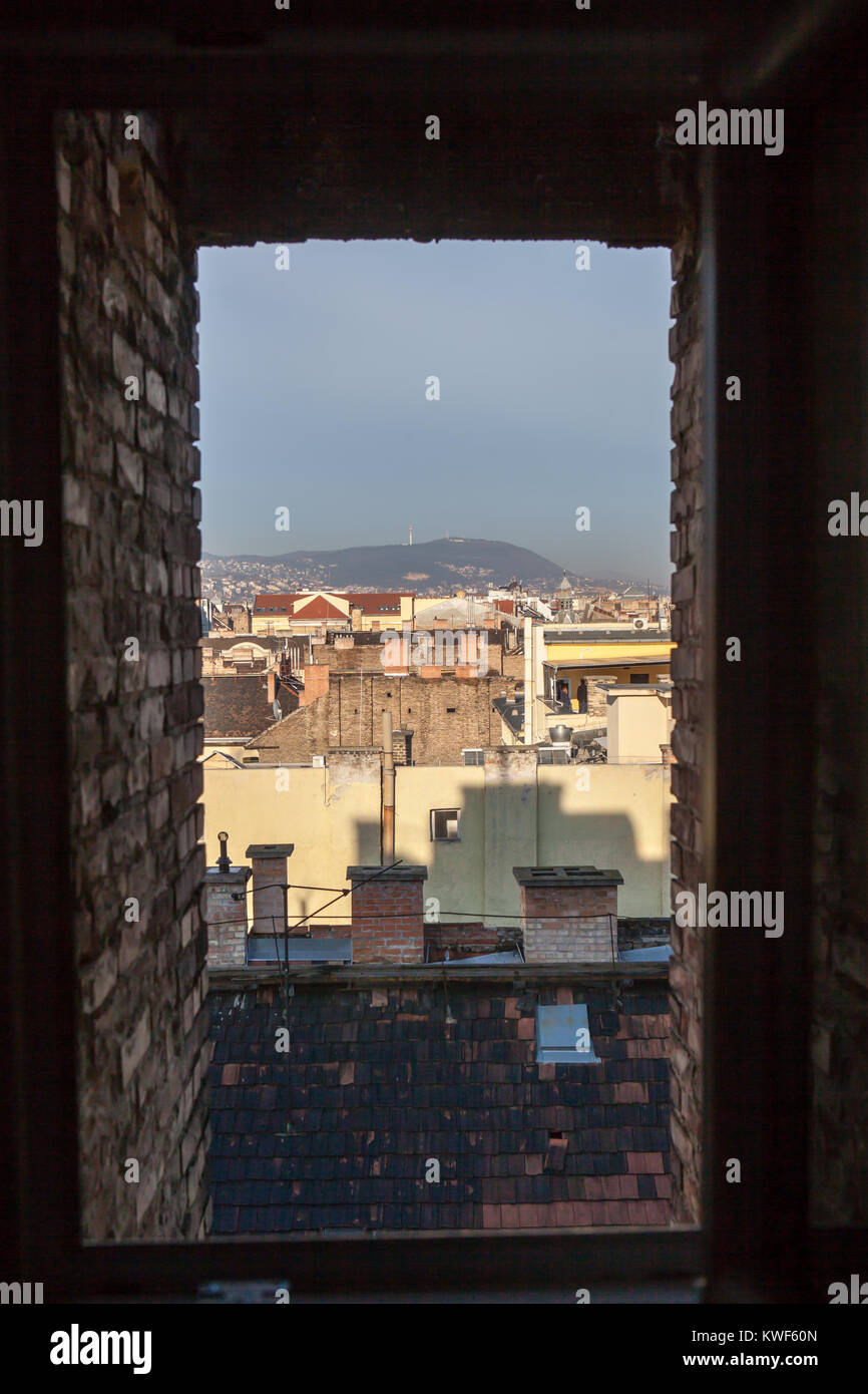 View of Budapest rooftops from a brick window in the centre of the city ...