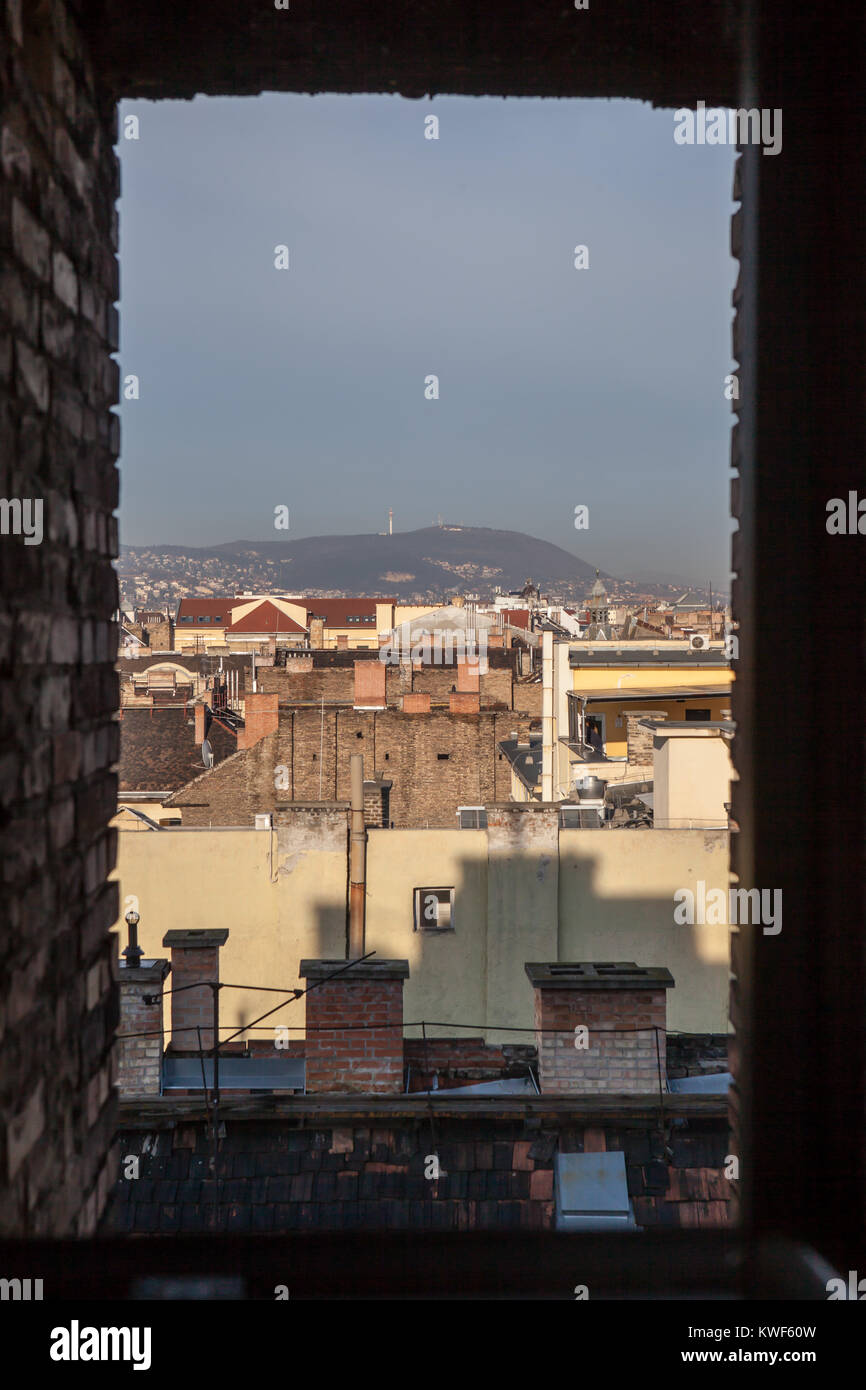 View of Budapest rooftops from a brick window in the centre of the city ...
