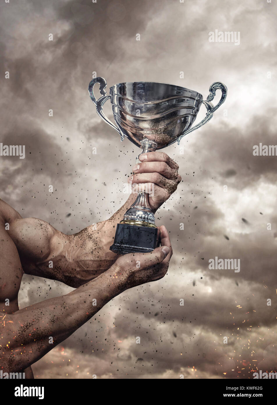 Cropped hand of athlete holding trophy against epic background Stock ...