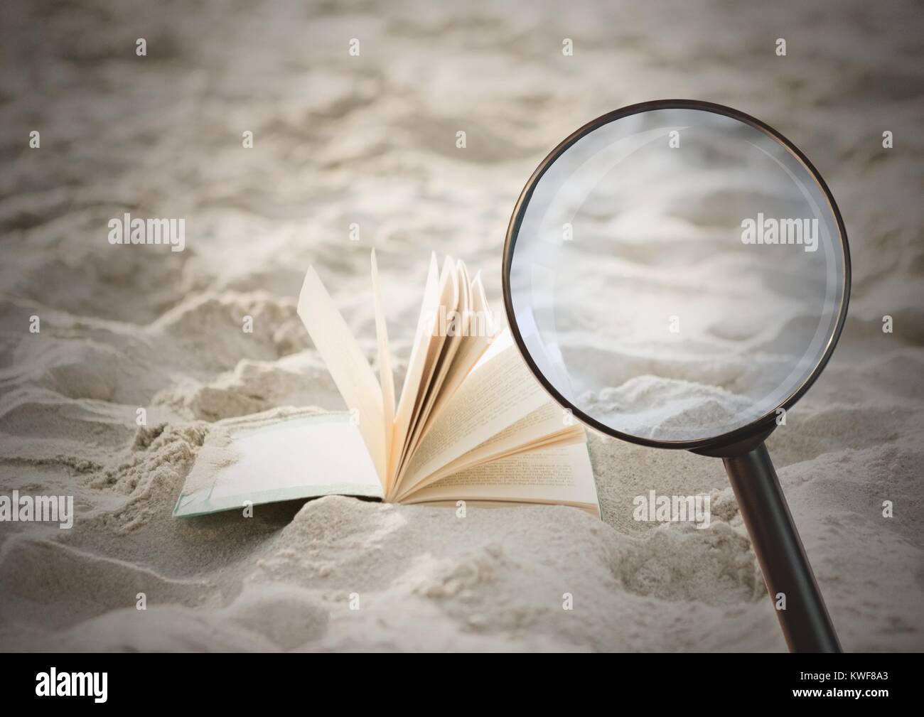 3D Magnifying glass over book in sand Stock Photo - Alamy