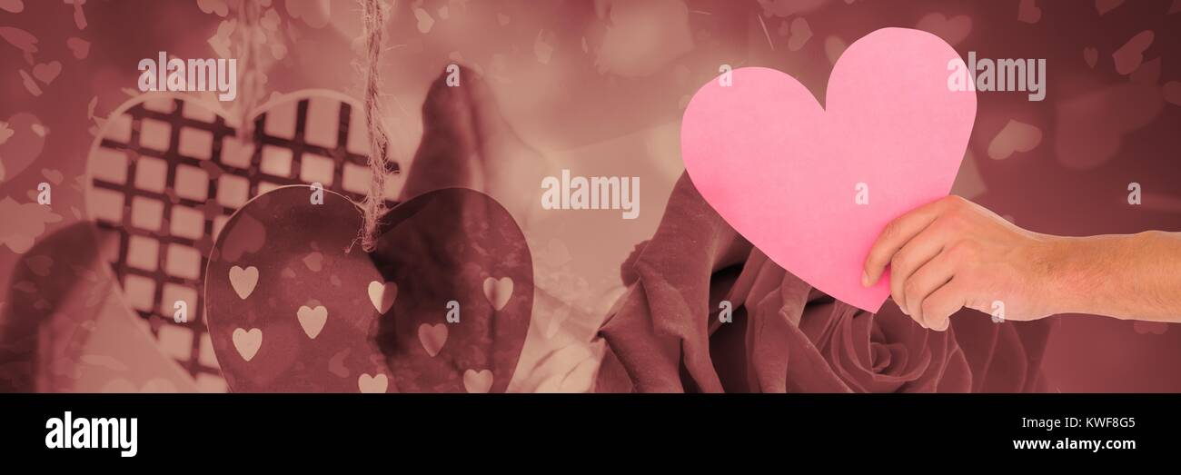 Valentines heart in hand with love hearts background Stock Photo - Alamy