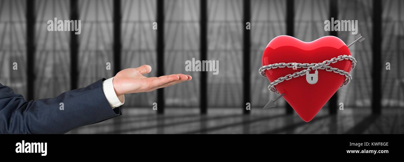 open hand and heart locked in chains by office window Stock Photo - Alamy