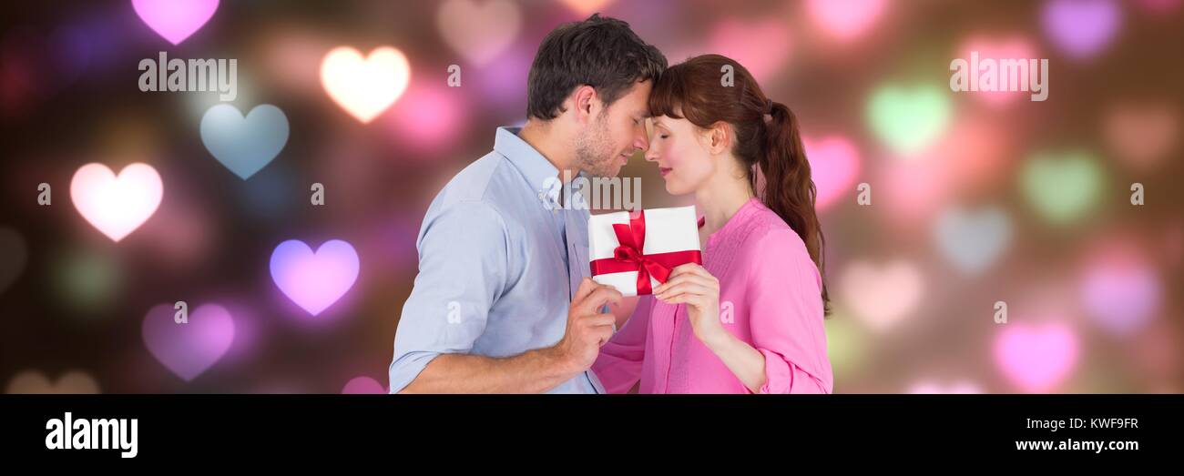 Valentines couple giving presents with love hearts background Stock ...