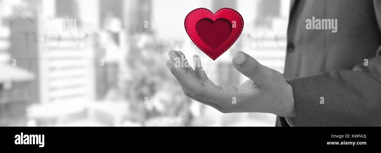 open hand and heart in front of city Stock Photo - Alamy