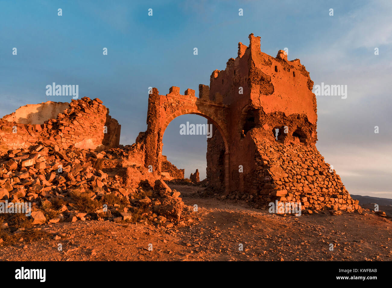 Last sun on the glowing amber stonework of Mhirleft Kasbah. Moroccan ...