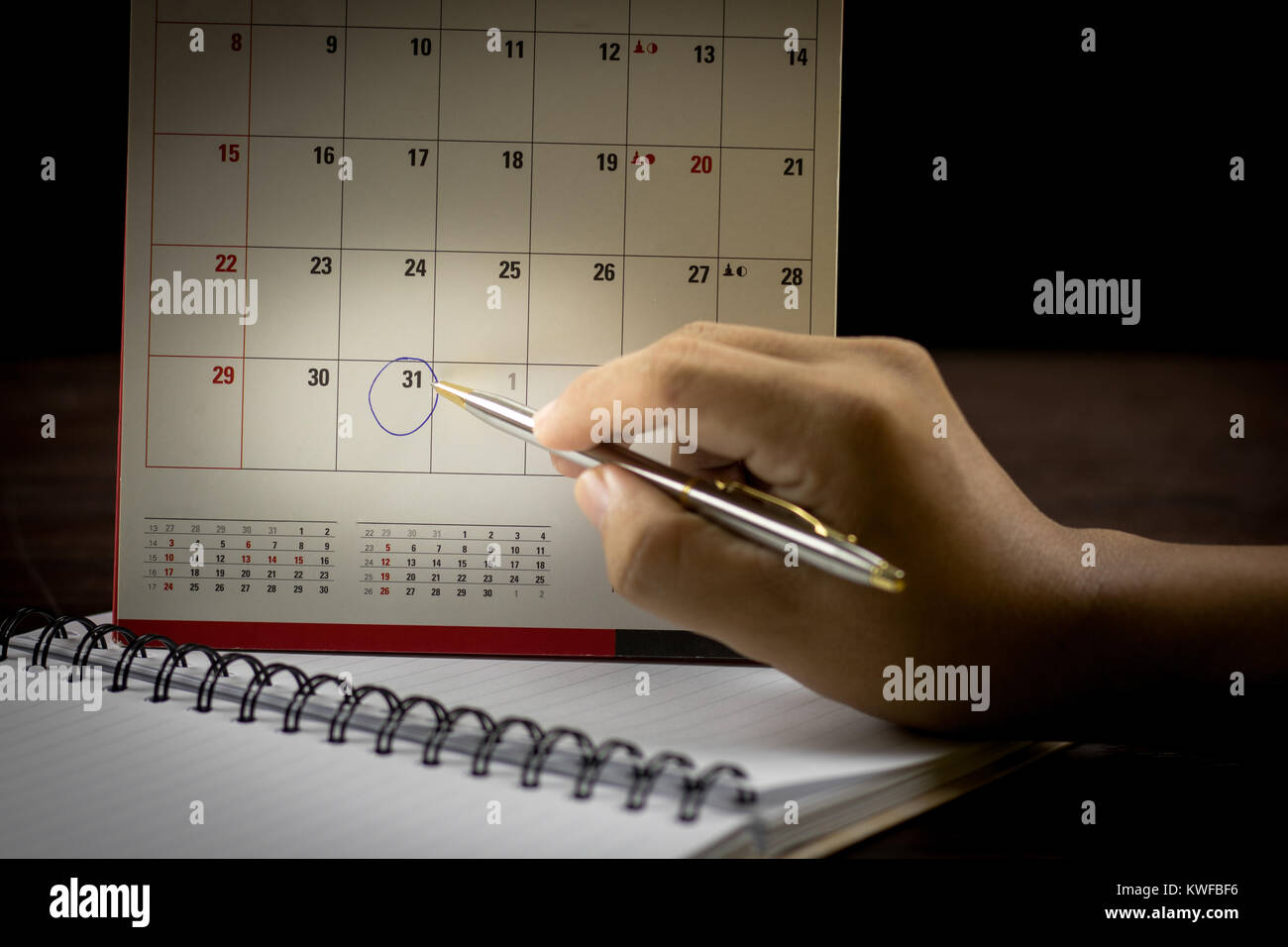 hand with pen writing on calender for note or make and plan hand ...
