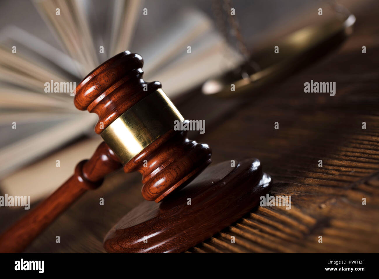 Gavel of judge on rustic wooden table. Bookshelf background Stock Photo ...