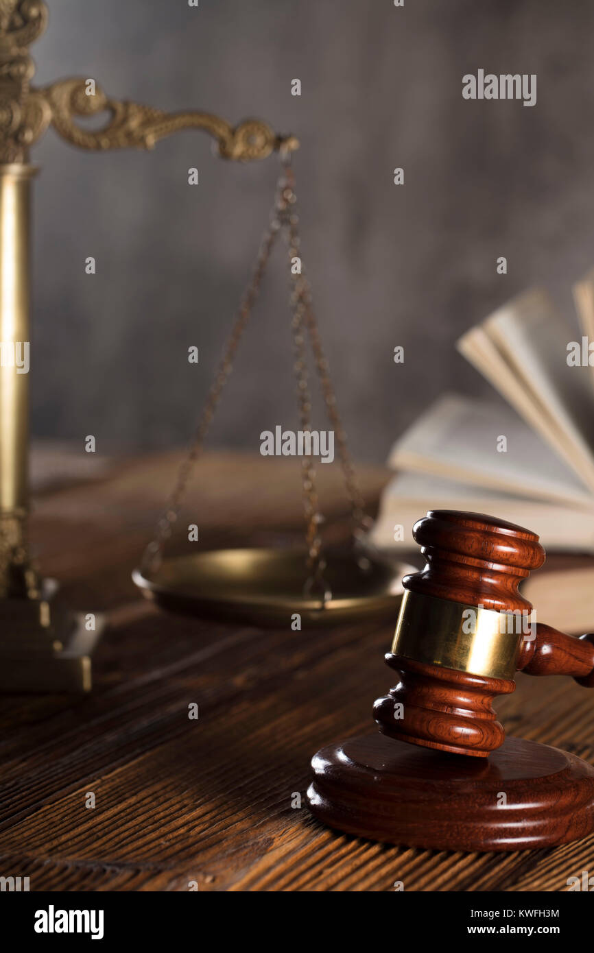 Gavel of judge on rustic wooden table. Bookshelf background Stock Photo ...