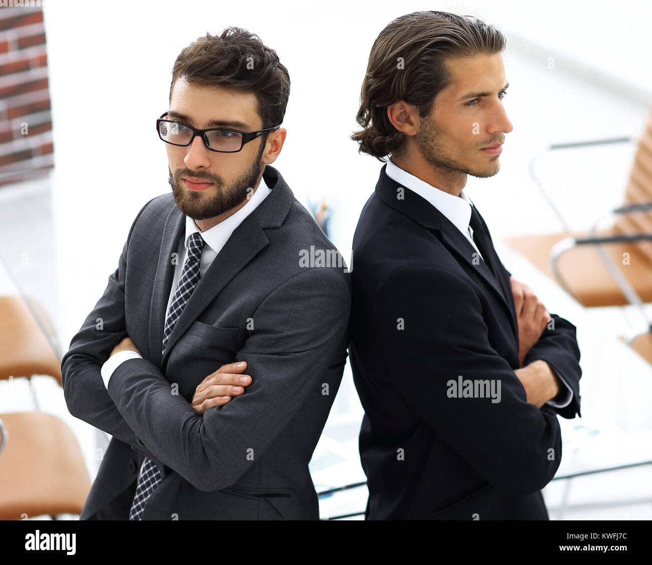 Two men standing back to back and support each other Stock Photo - Alamy